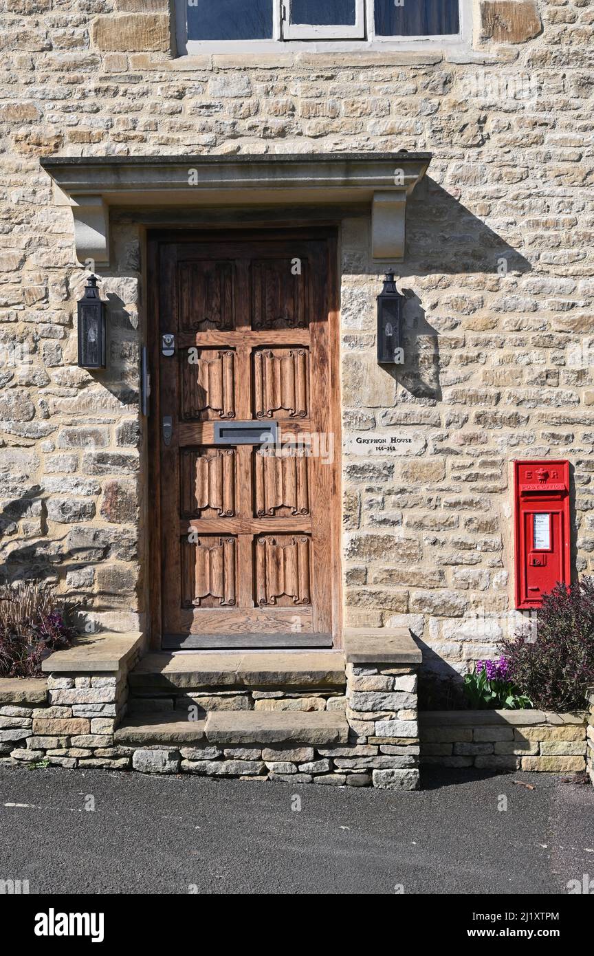 Gryphon House on the High Street in Burford, Oxfordshire has a red ...