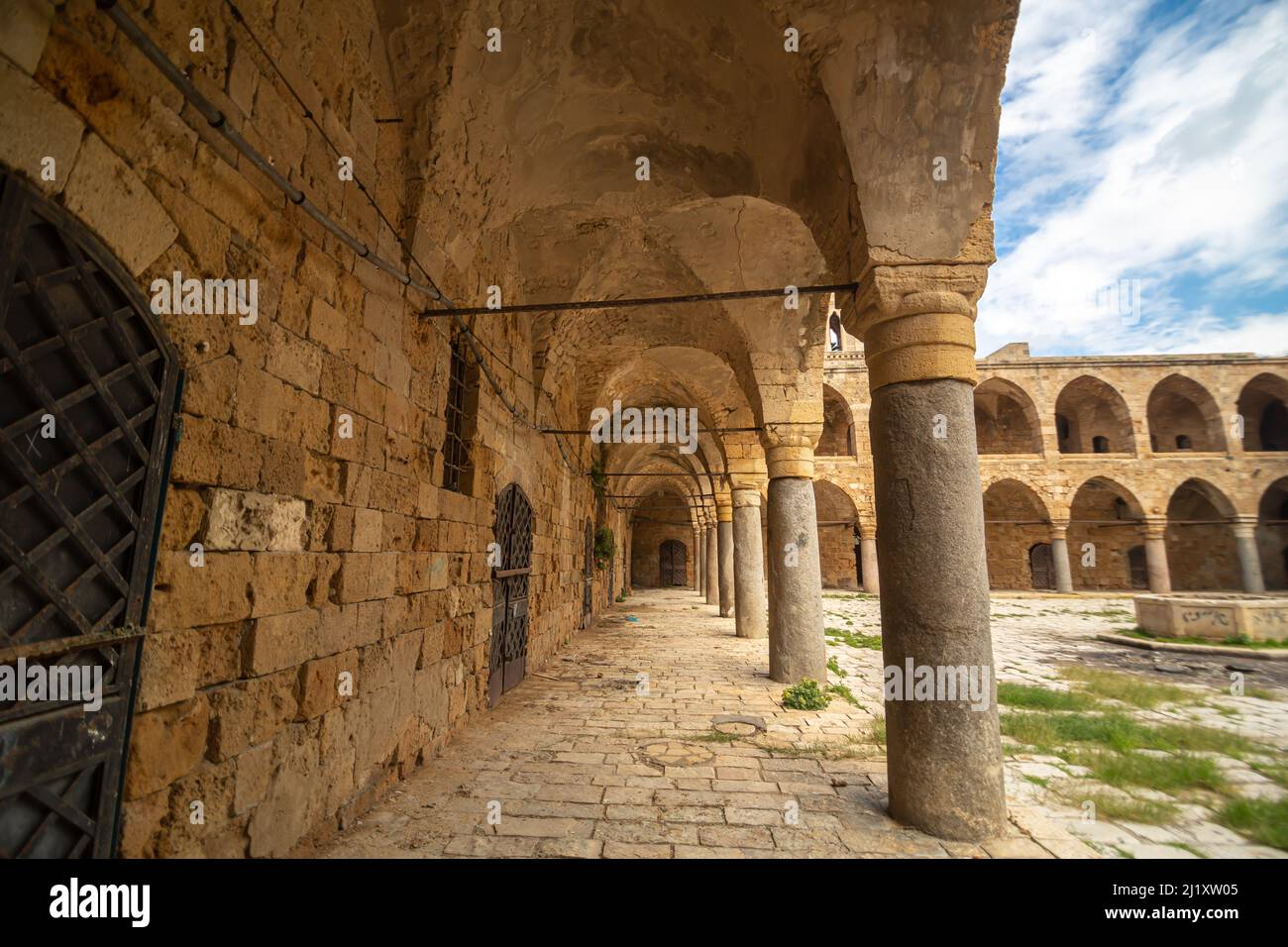 Medieval square building with a courtyard and many arches Stock Photo ...