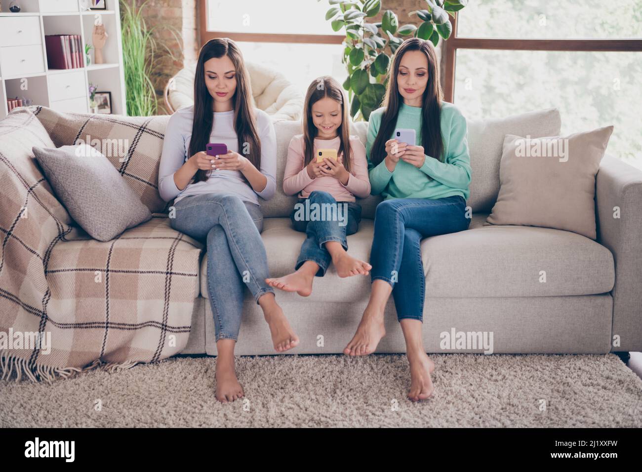 Full length photo of mommy siblings rest free-time use mobile childhood ...