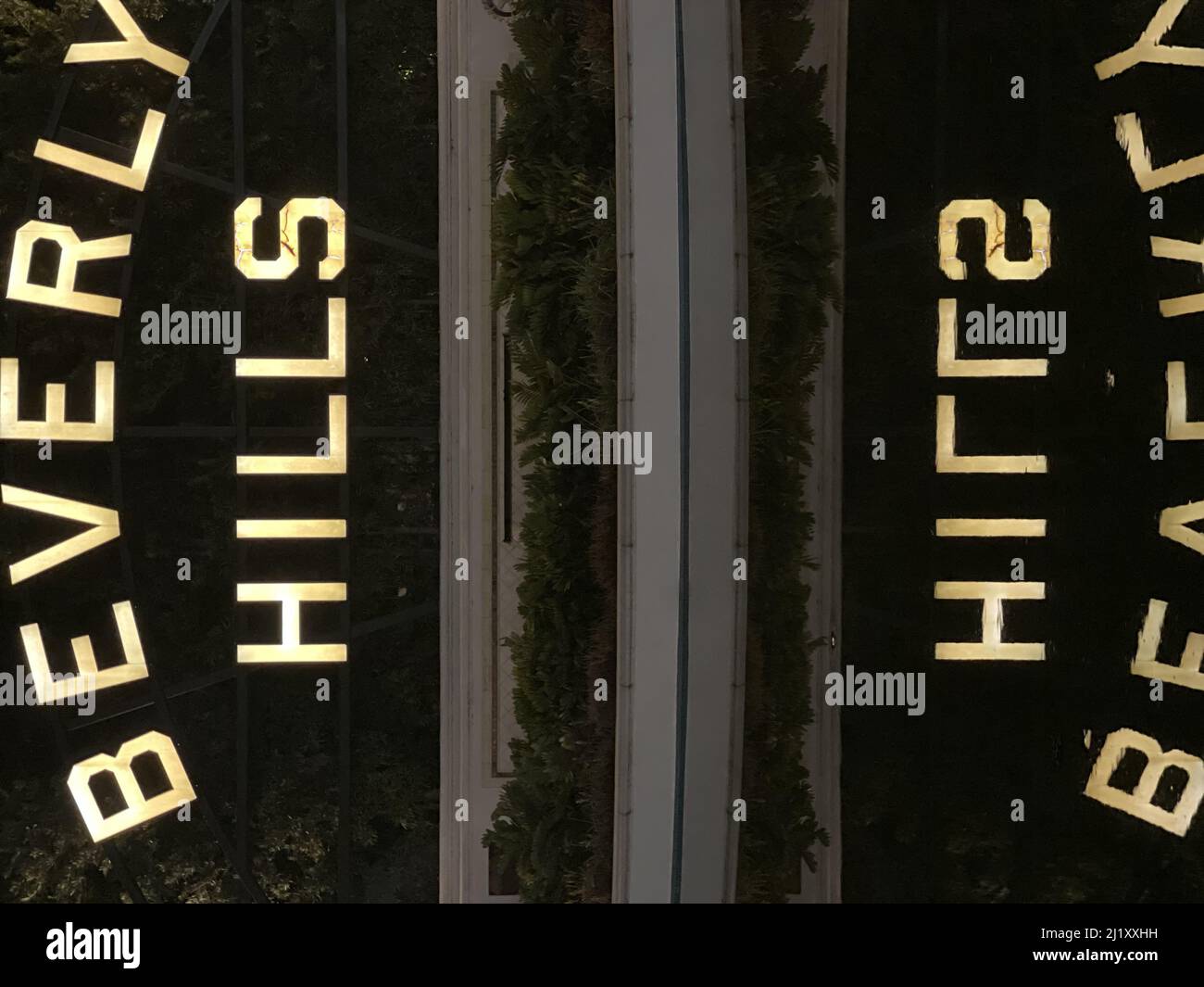 A vertical shot of the famous Beverly Hills sign in the dark and its ...