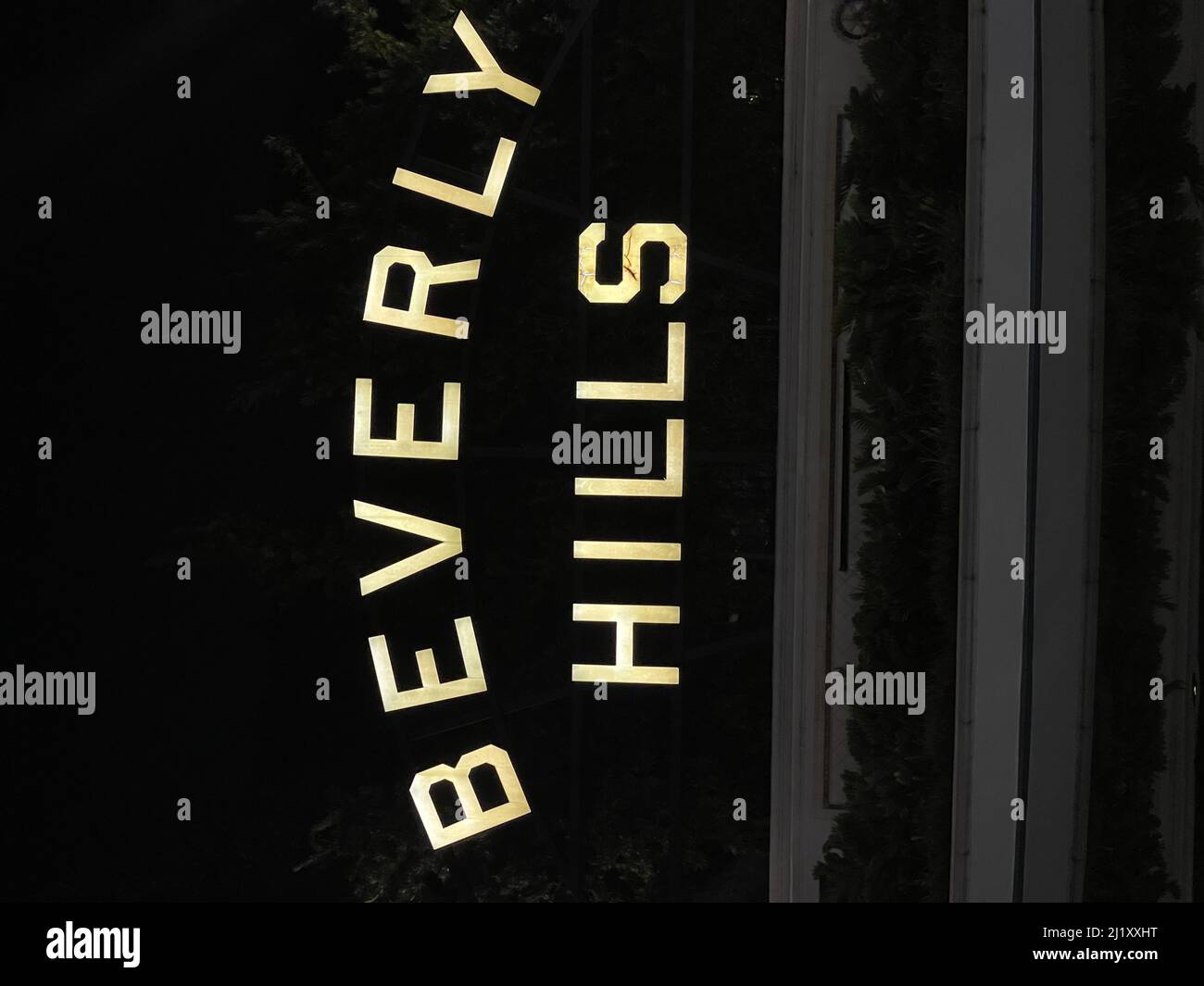 A vertical shot of the famous Beverly Hills sign in the dark Stock ...