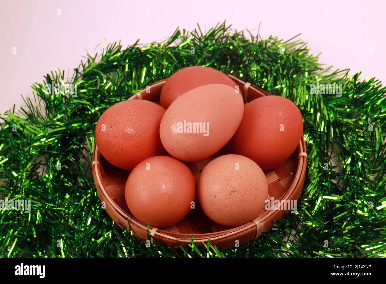 Studio photo of Easter Close-Up of Eggs in a Basket Green Vines on ...
