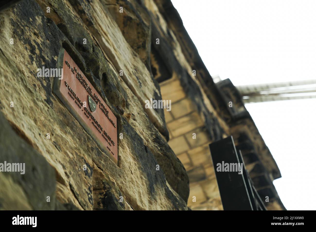 A low angle shot of a plaque mounted on the historical Wheeling ...