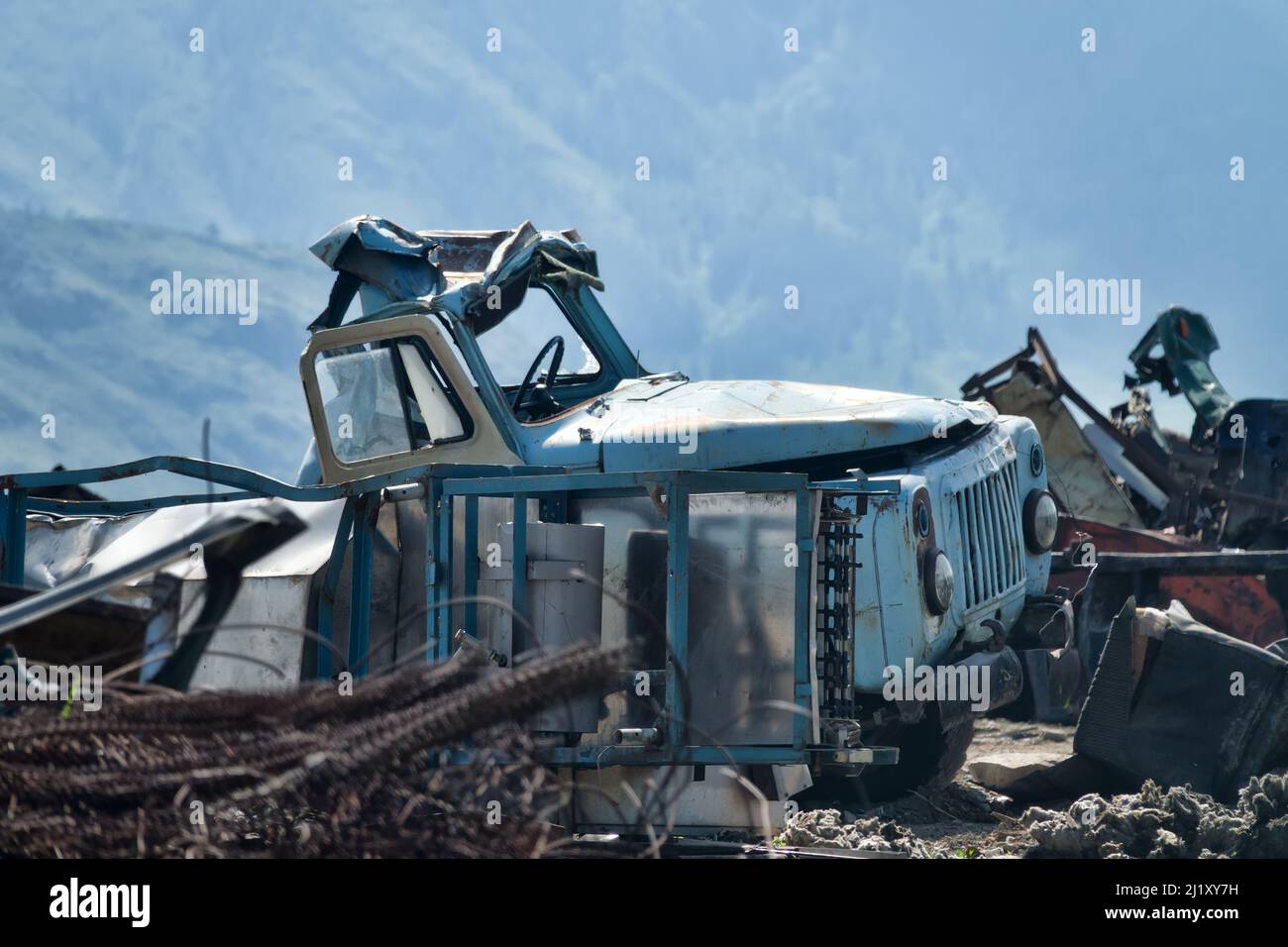 A mountain of scrap metal in the mountains. Pollution of nature by ...