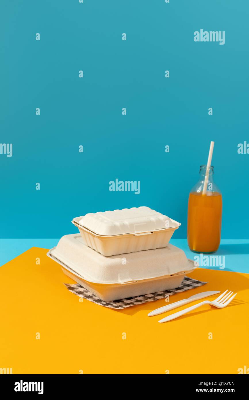 Lunchboxes, cutlery and drinks on orange table. Food delivery concept ...