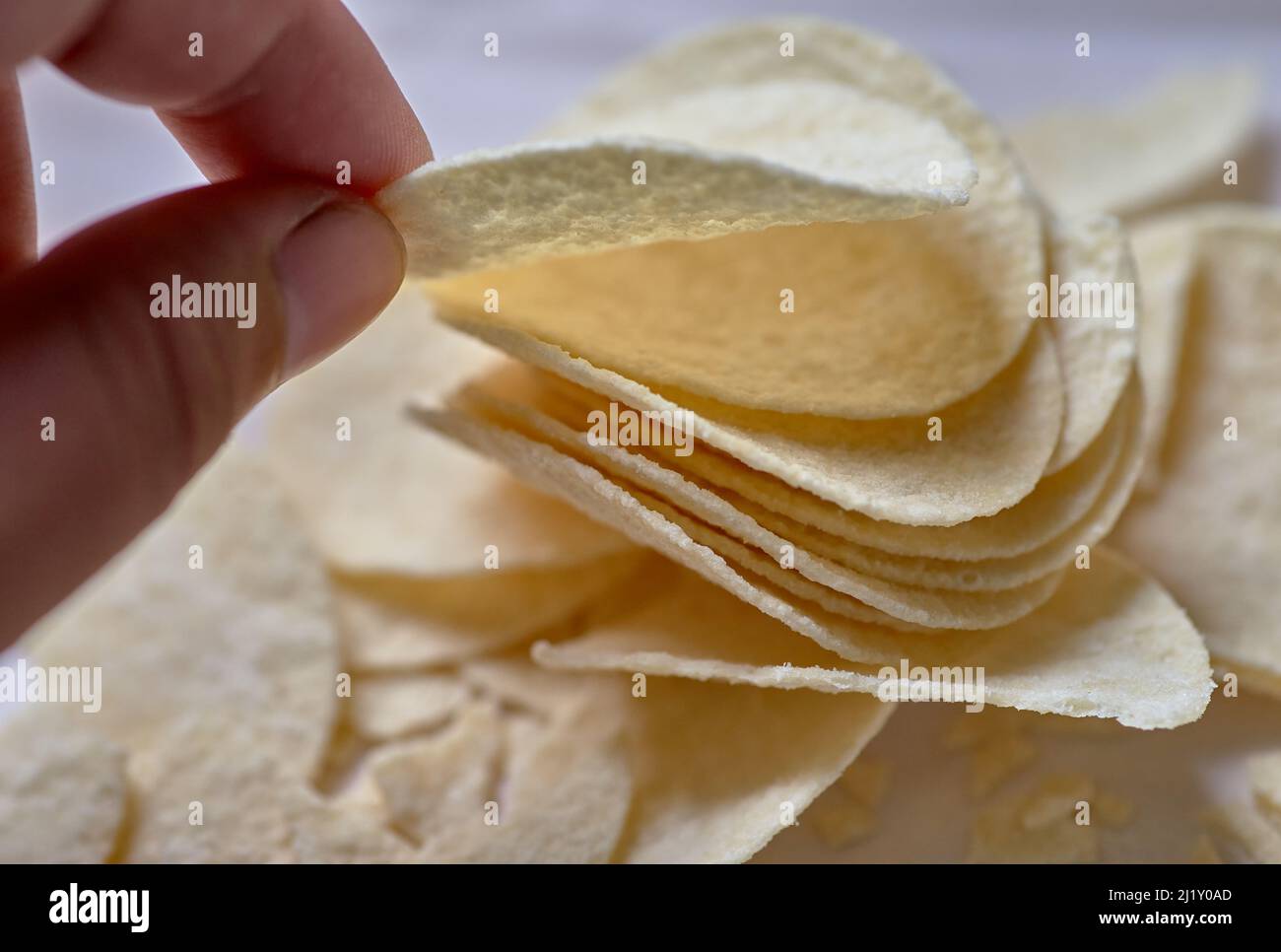 Close-up view of a hand picking potato chips Stock Photo - Alamy