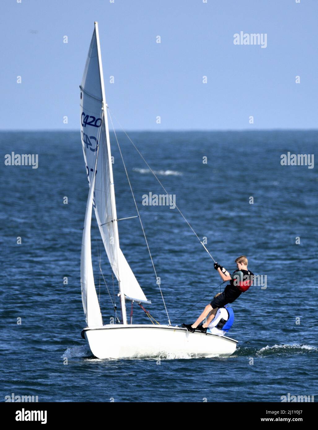 A vertical closeup shot of the small sailboat in the ocean of the Dana ...