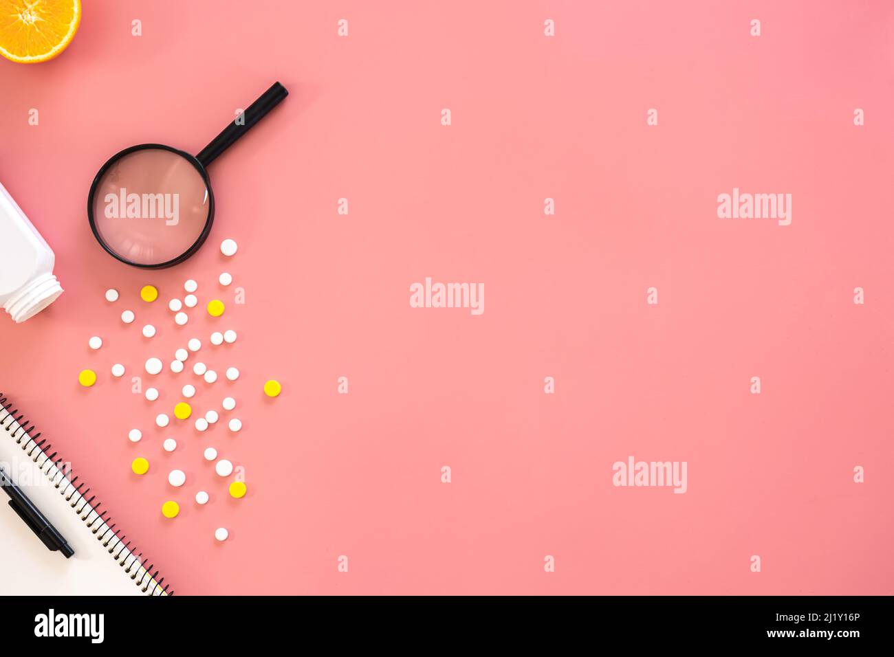 Flat lay, pills and magnifier on pink background, copy space Stock ...