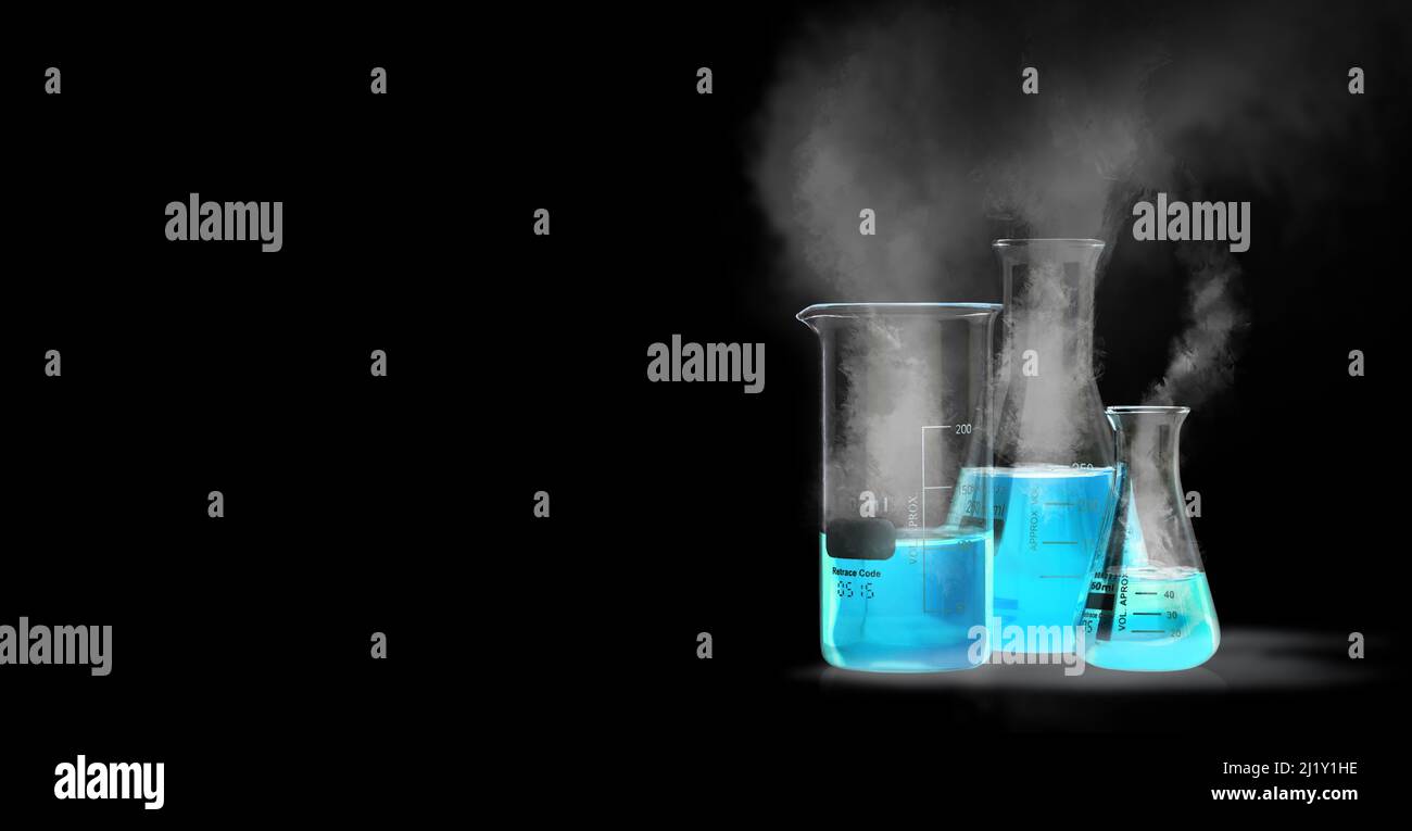 Flasks with blue liquid isolated on black background with smoke Stock ...