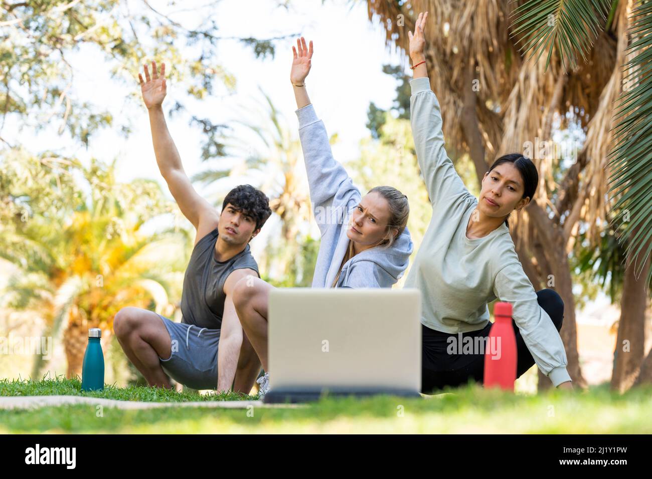 Three young people doing sports with a laptop and in the park Stock ...