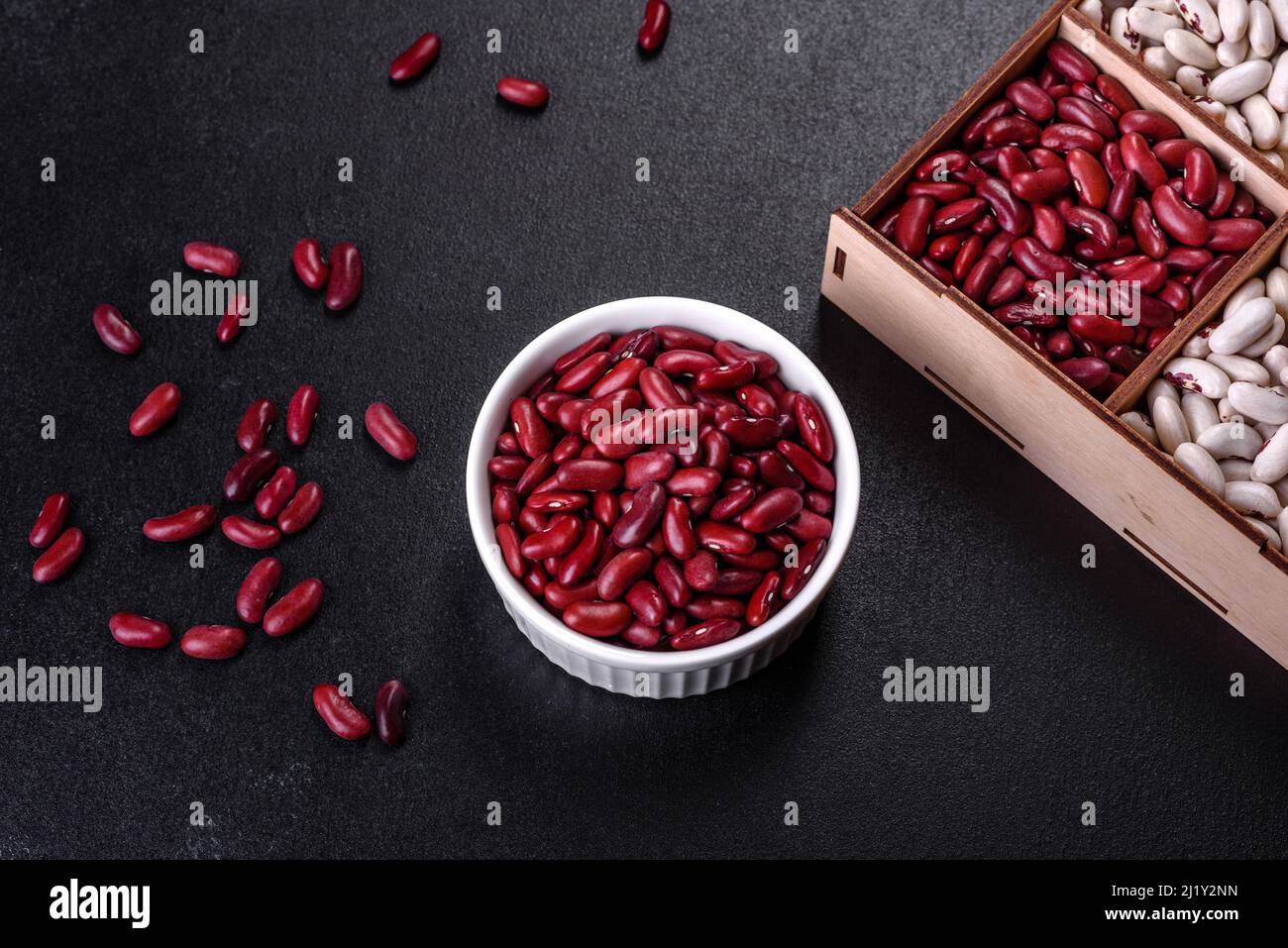 Beans of red dry raw beans on a dark concrete background. Cooking ...