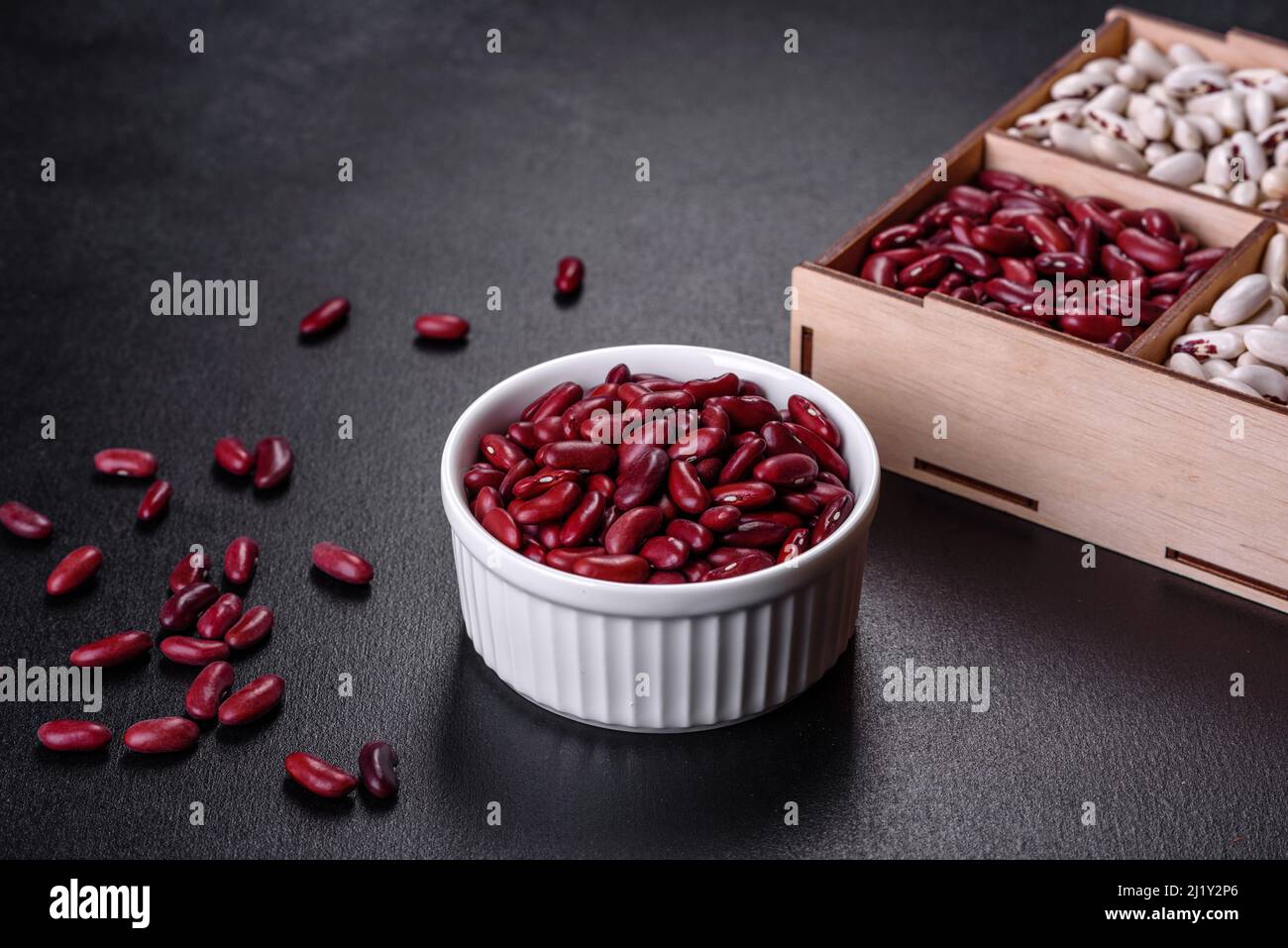 Beans of red dry raw beans on a dark concrete background. Cooking ...