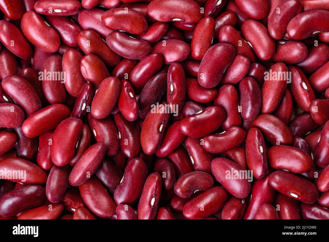 Beans of red dry raw beans on a dark concrete background. Cooking ...