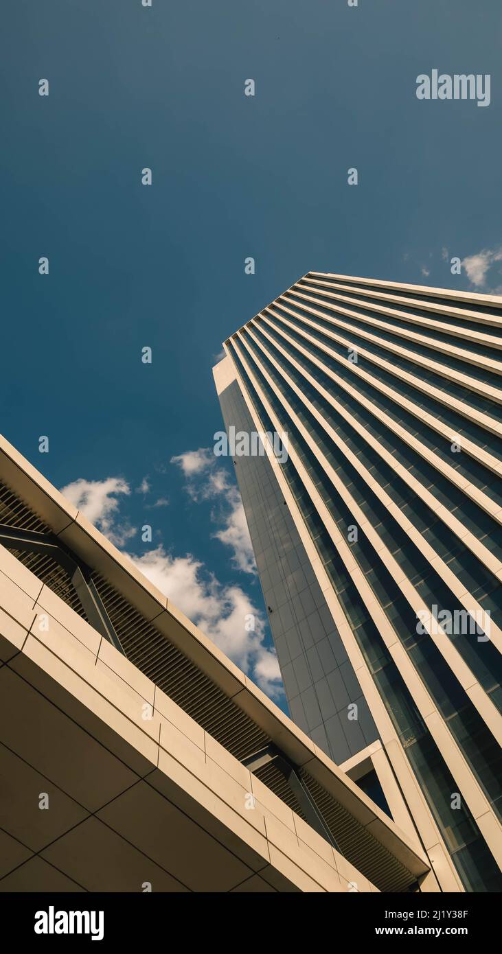 A vertical low angle shot of the GTC tower on a sunny day in Nairobi ...