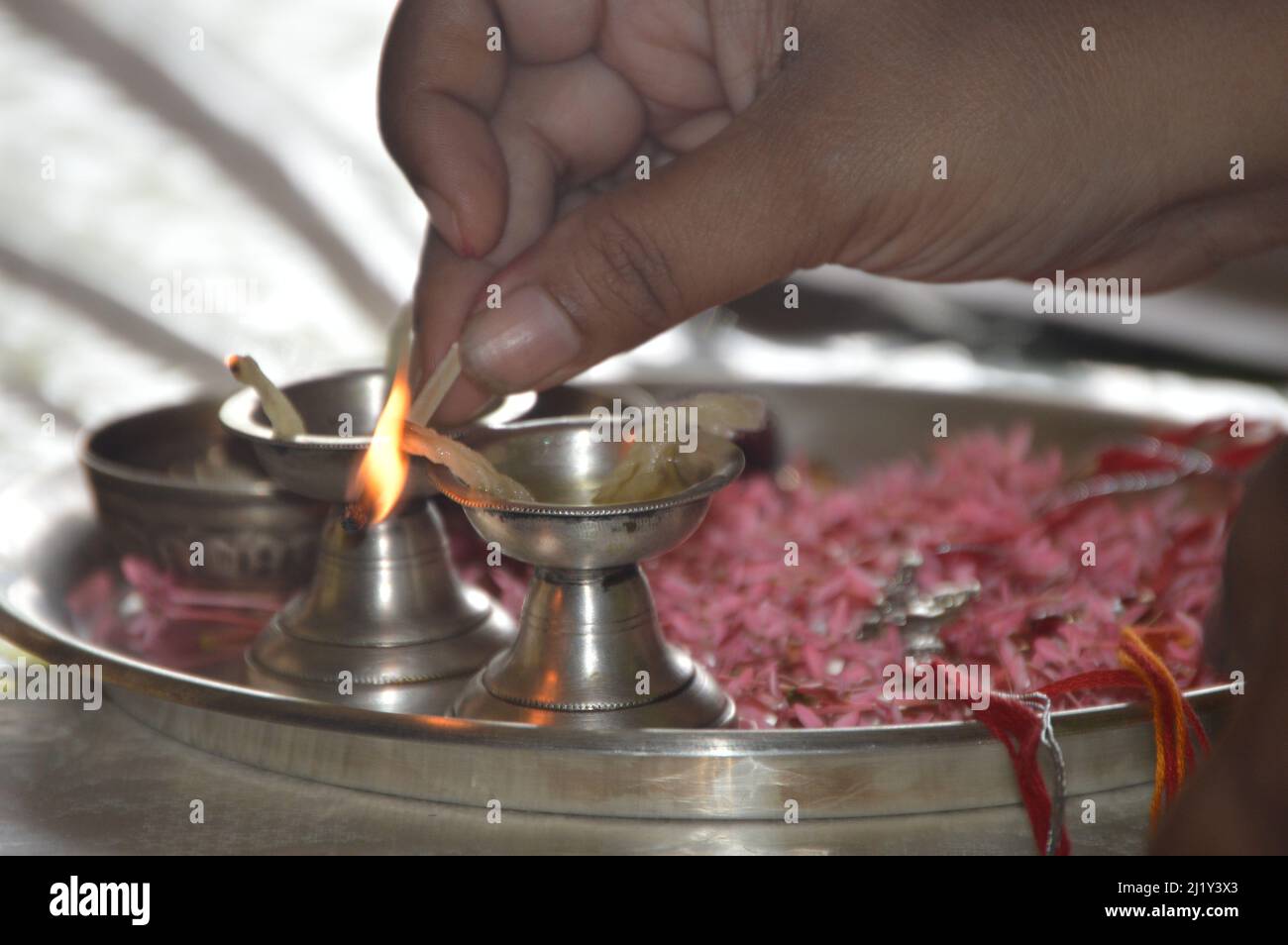 The Caucasian hand lighting butter lamps Stock Photo - Alamy