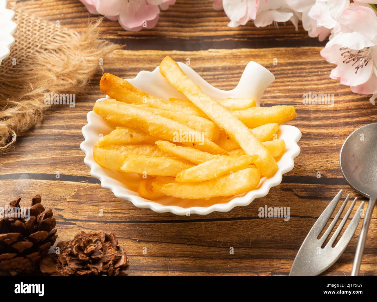 crispy potato fries, french fries in dish side view on wooden table ...