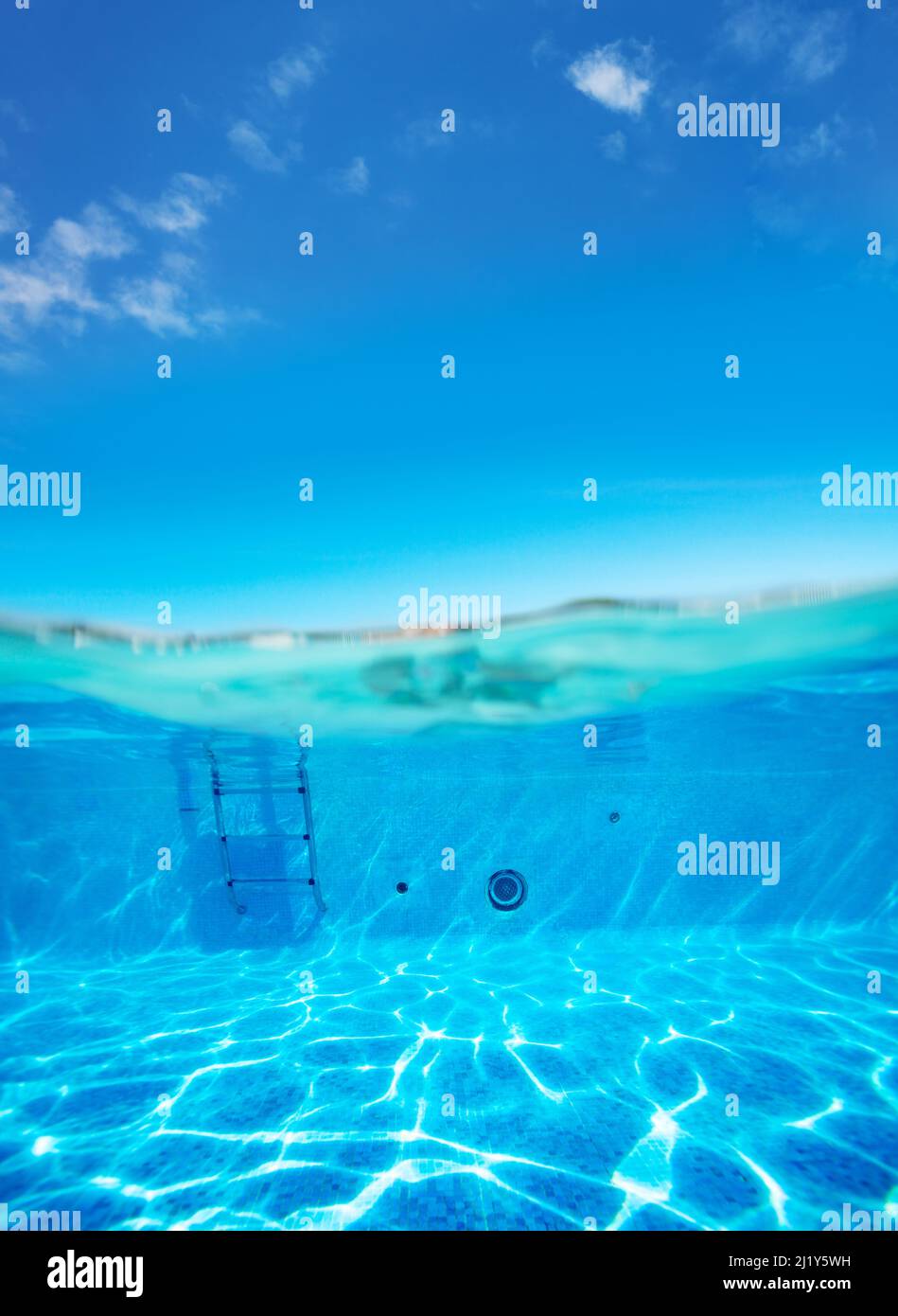 Split underwater pool photo of rails and ladder stairs Stock Photo - Alamy