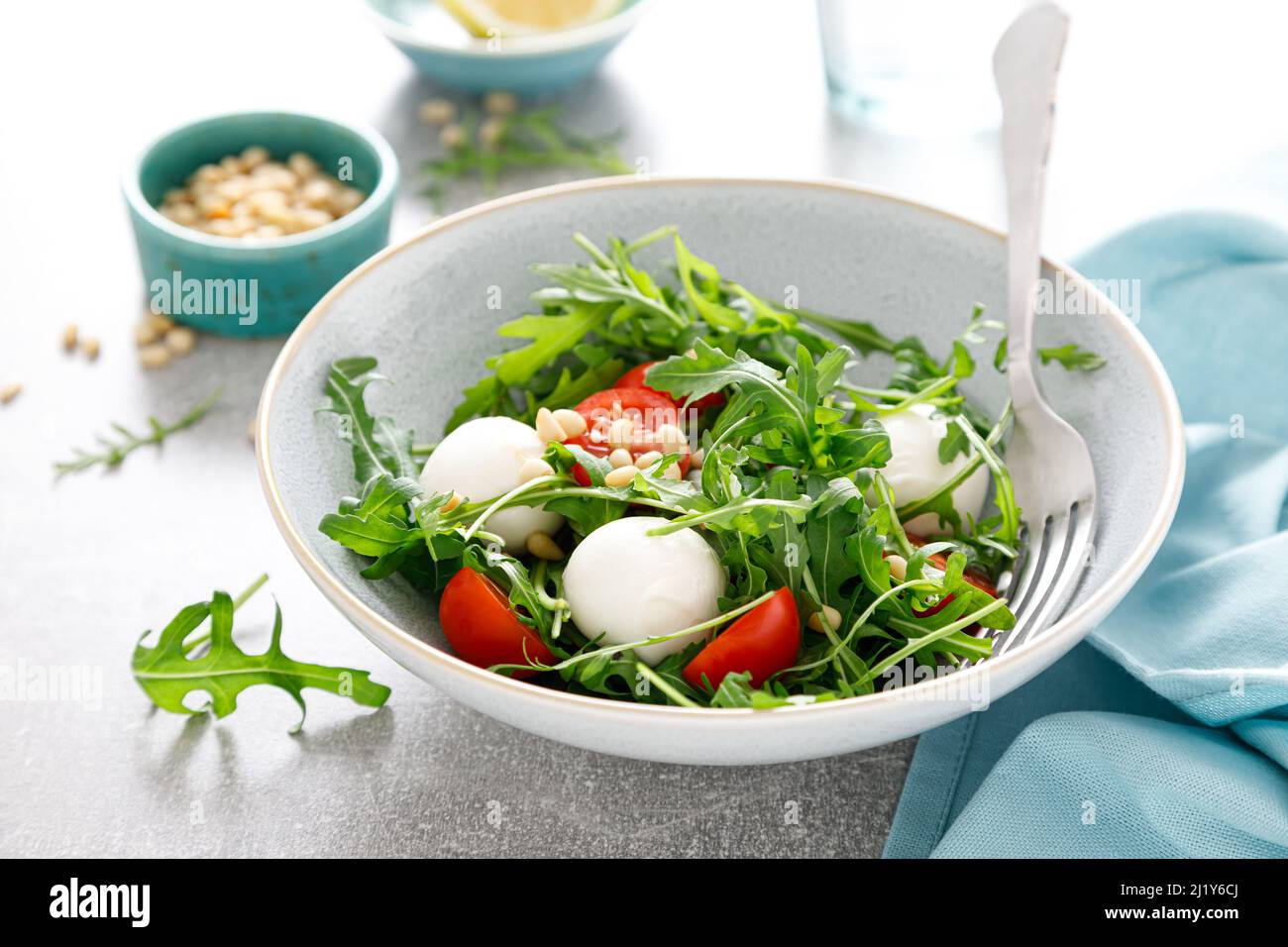 Fresh vegetable Caprese salad with arugula, tomato, pine nuts and mini ...