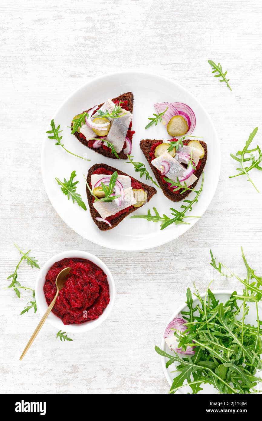 Sandwiches with salted herring fillet and beetroot pate. Top view ...