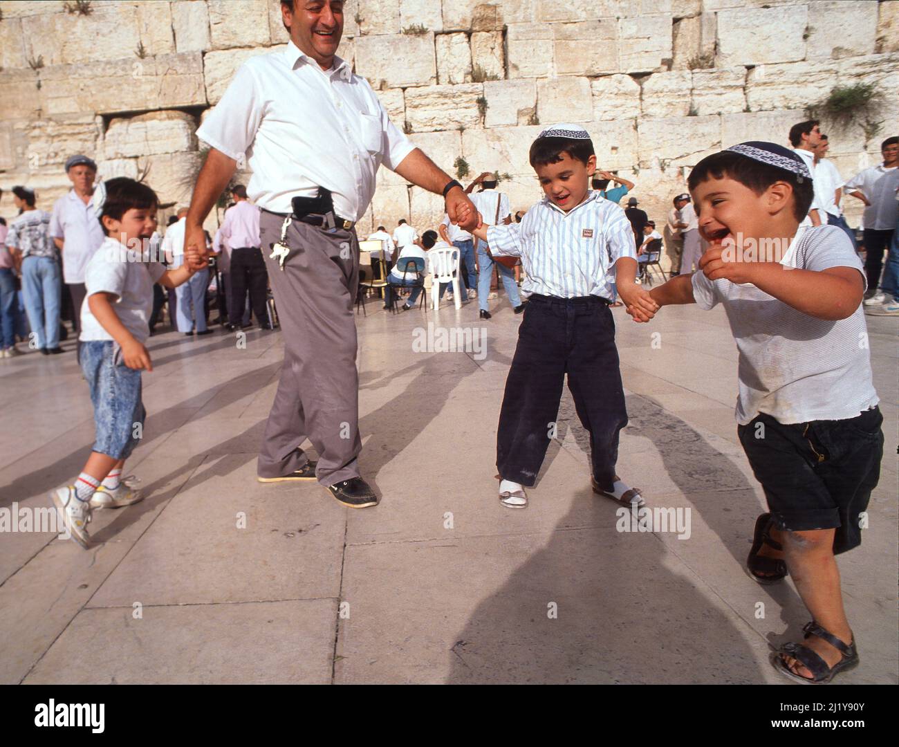 Israeli Jewish man dances around with some children near the West Wall ...