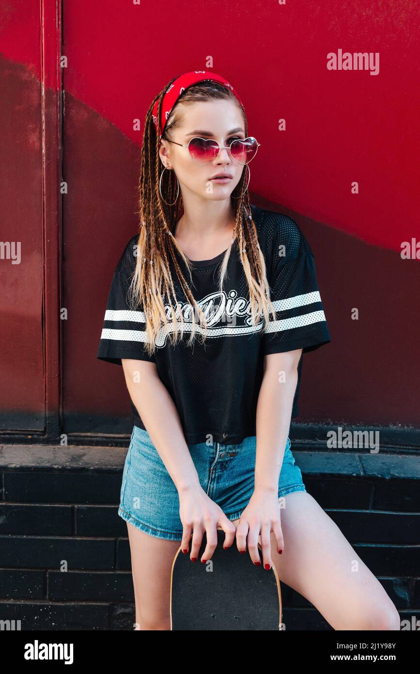 Fashion portrait ofyoung woman in red hipster band and sunglasses with ...