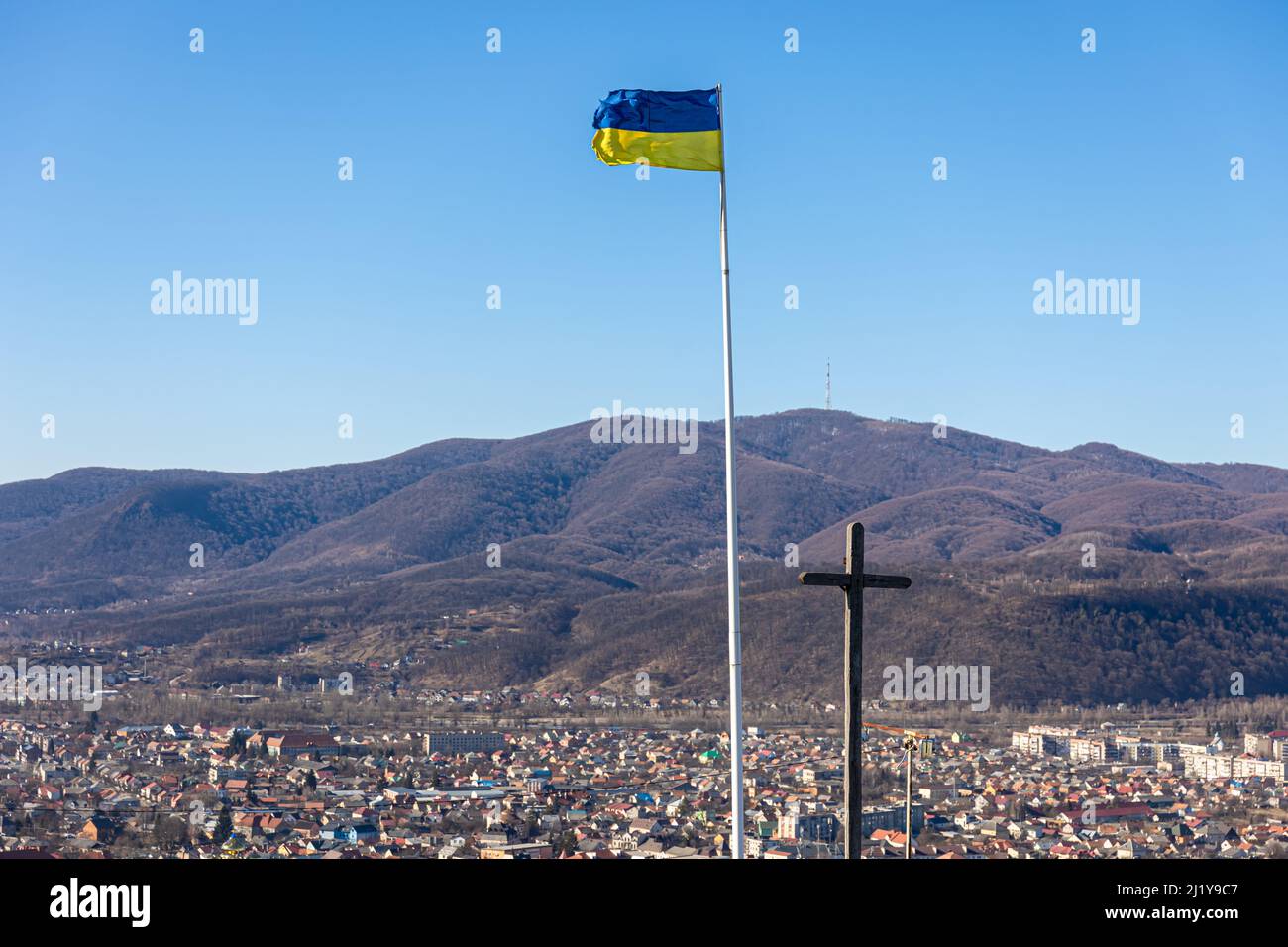 Ukrainian flag and cross on the background of mountains Stock Photo - Alamy
