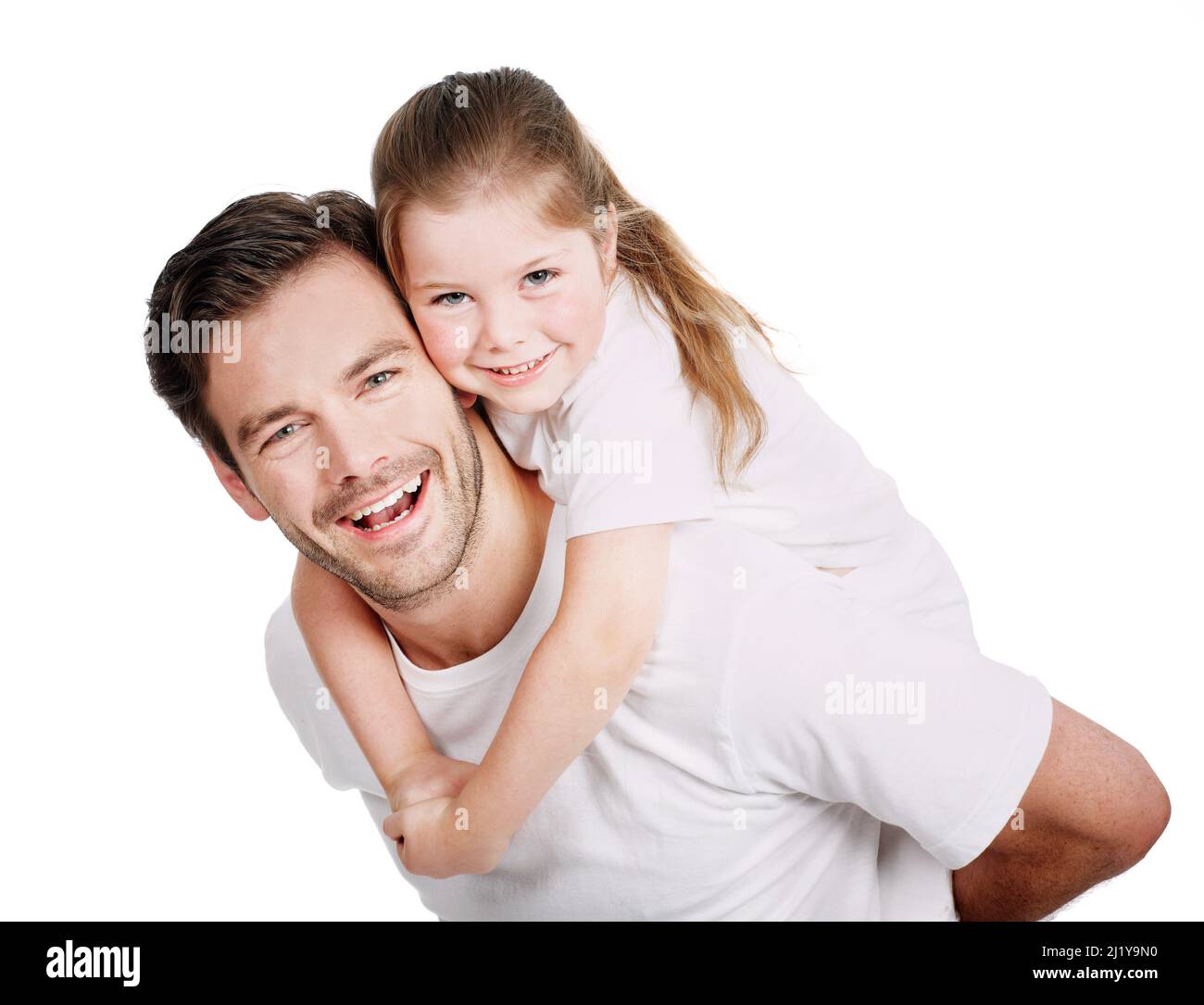 Giving his little girl a piggyback ride. Studio shot of a young dad carrying his little girl on ...