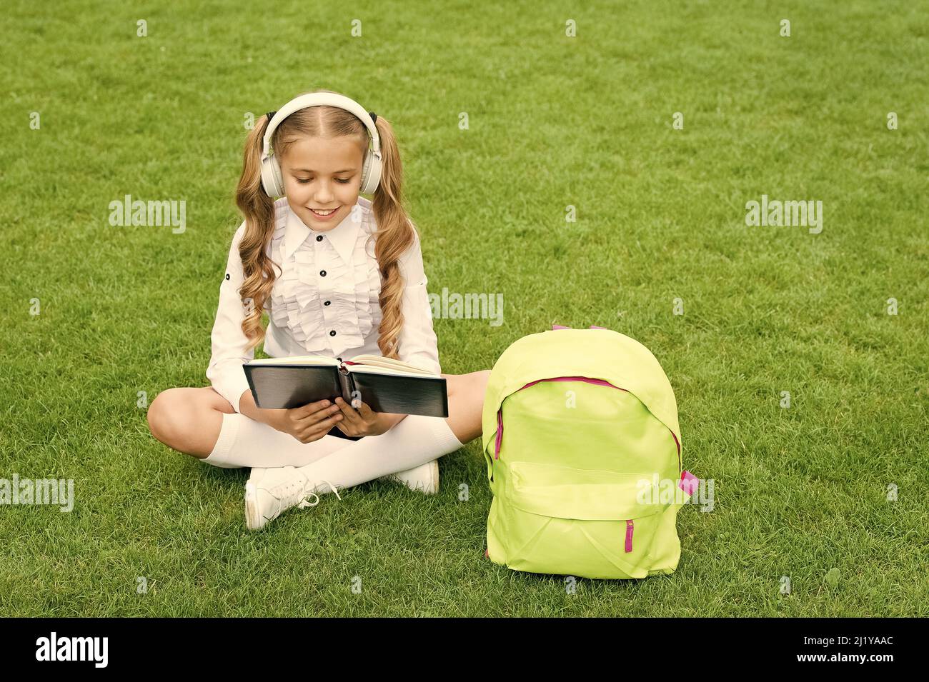 Language learning course. Girl child learn English sitting on green ...