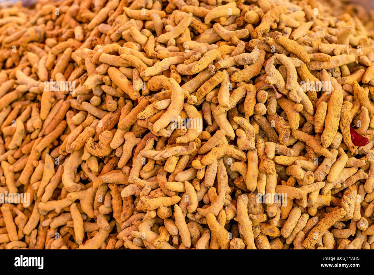 A pile of dried yellow turmeric roots close up top view Stock Photo - Alamy