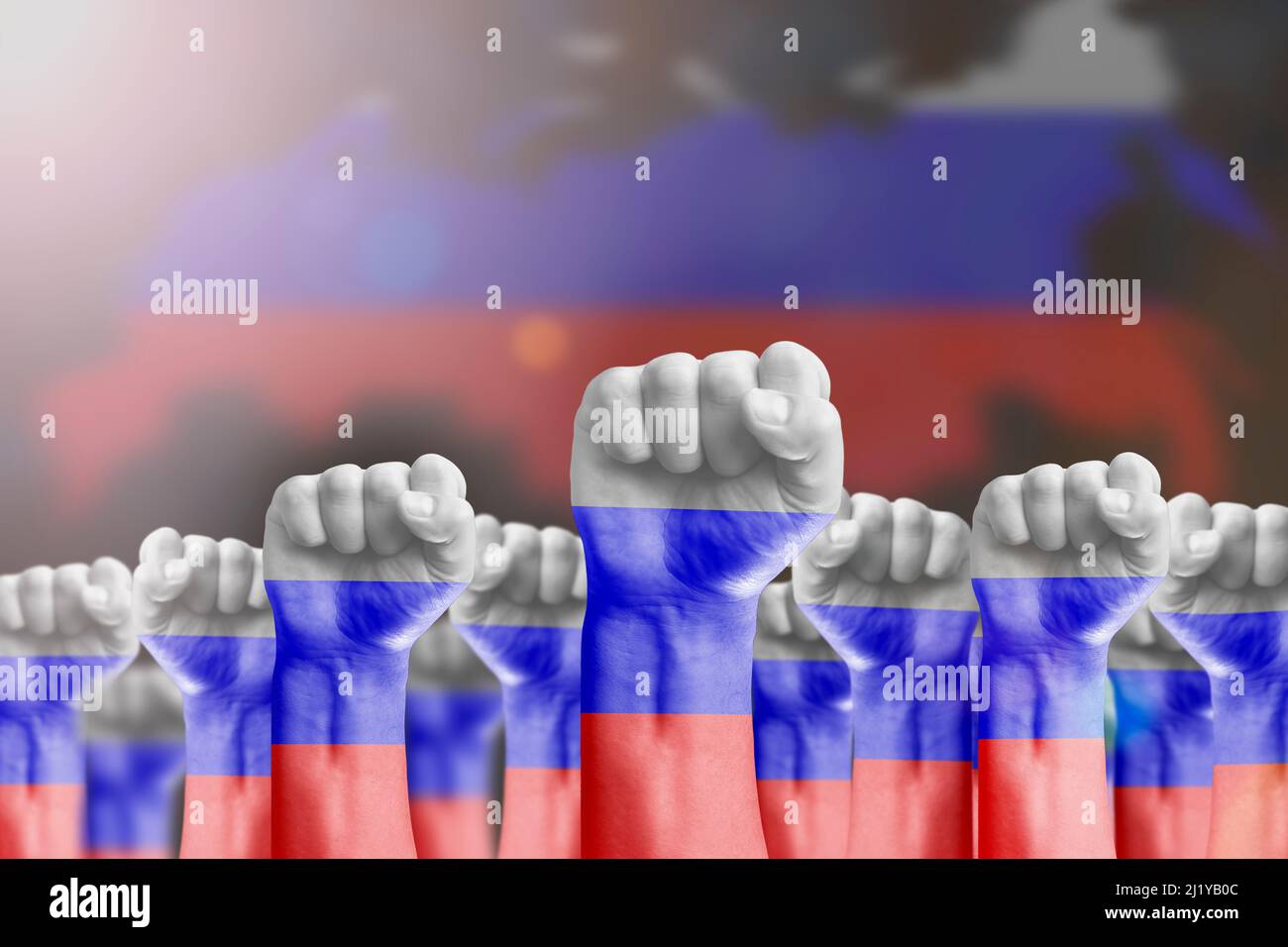 Raised fists against the background of the national flag of Russia. The ...