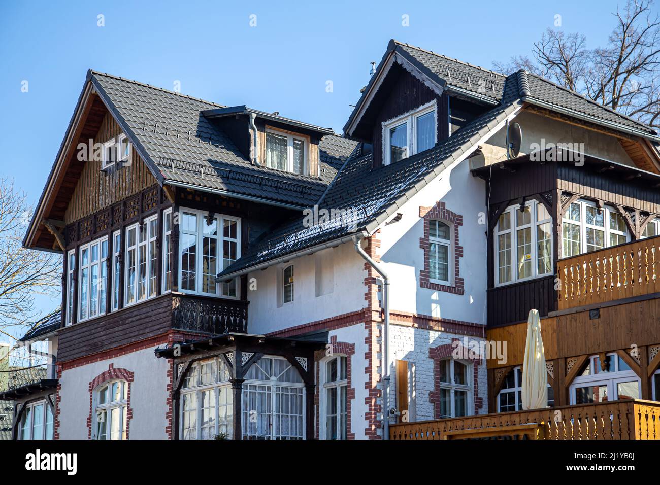 A beautiful textured house with wooden inserts and many add-ons Stock ...