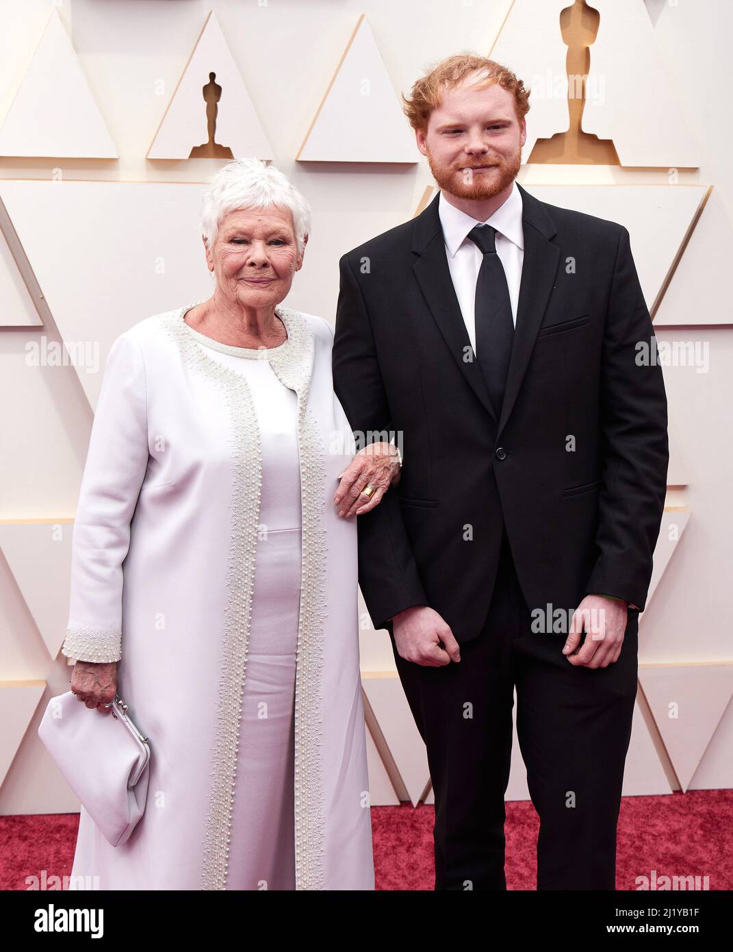 Dame Judy Dench and Sam Williams arriving on the red carpet of the 94th ...