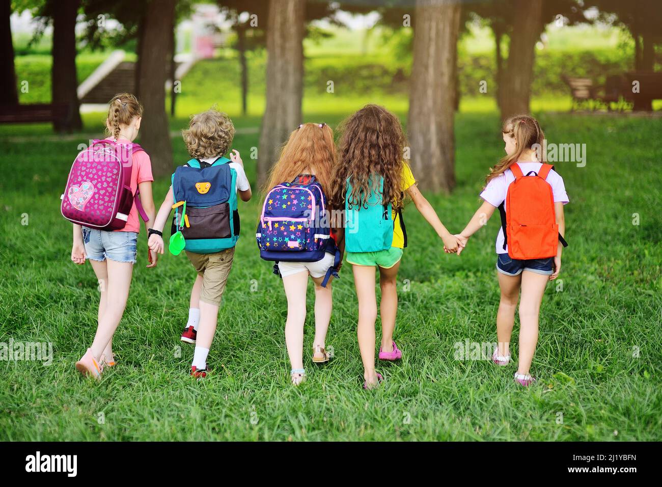 Children walking hand in hand back hi-res stock photography and images ...