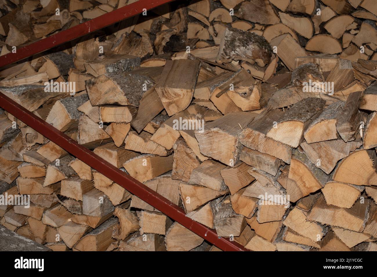 fixation of cut fuel wood with bars of varnished steel Stock Photo - Alamy