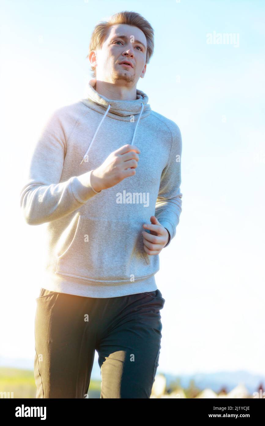 Running man jogging in rural nature at beautiful summer day. Sport ...