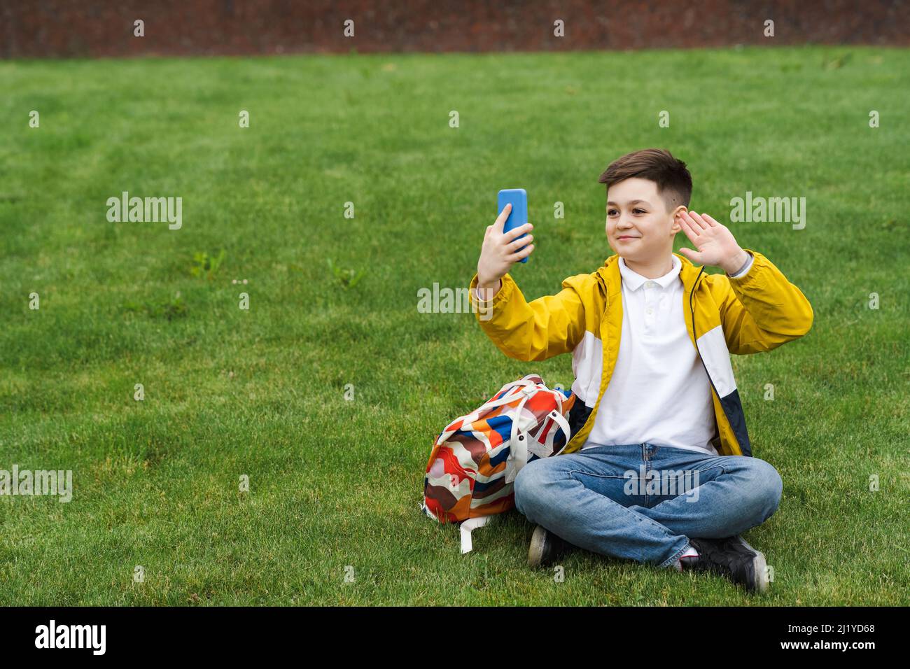 Schoolboy talking on phone green hi-res stock photography and images ...