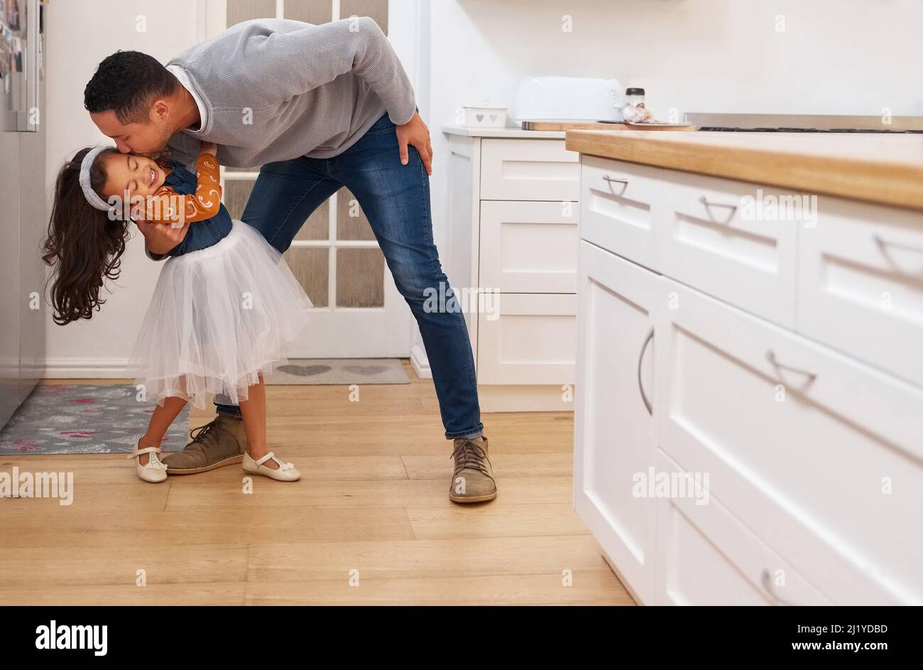 Come here with those cute cheeks. Shot of a father giving his daughter ...