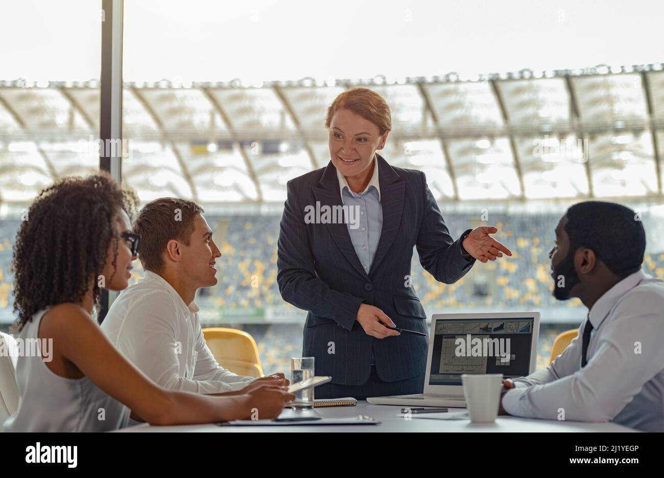 Multiracial coworkers group working together at office of stadium Stock ...