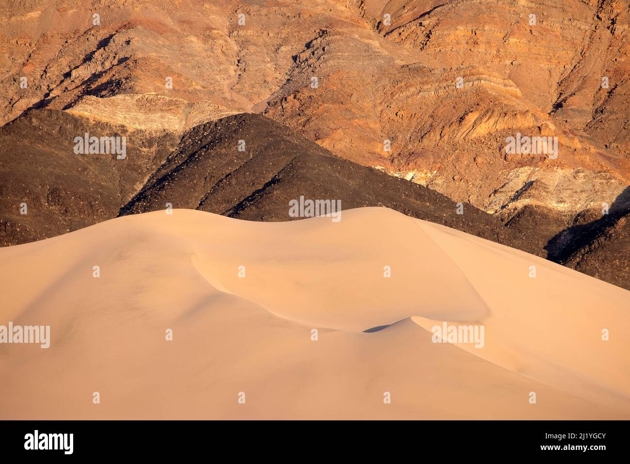 A late afternoon view of the Ibex Dunes backed by the Saddle Peak ...