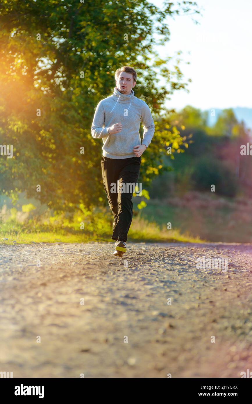 Running man jogging in rural nature at beautiful summer day. Sport ...