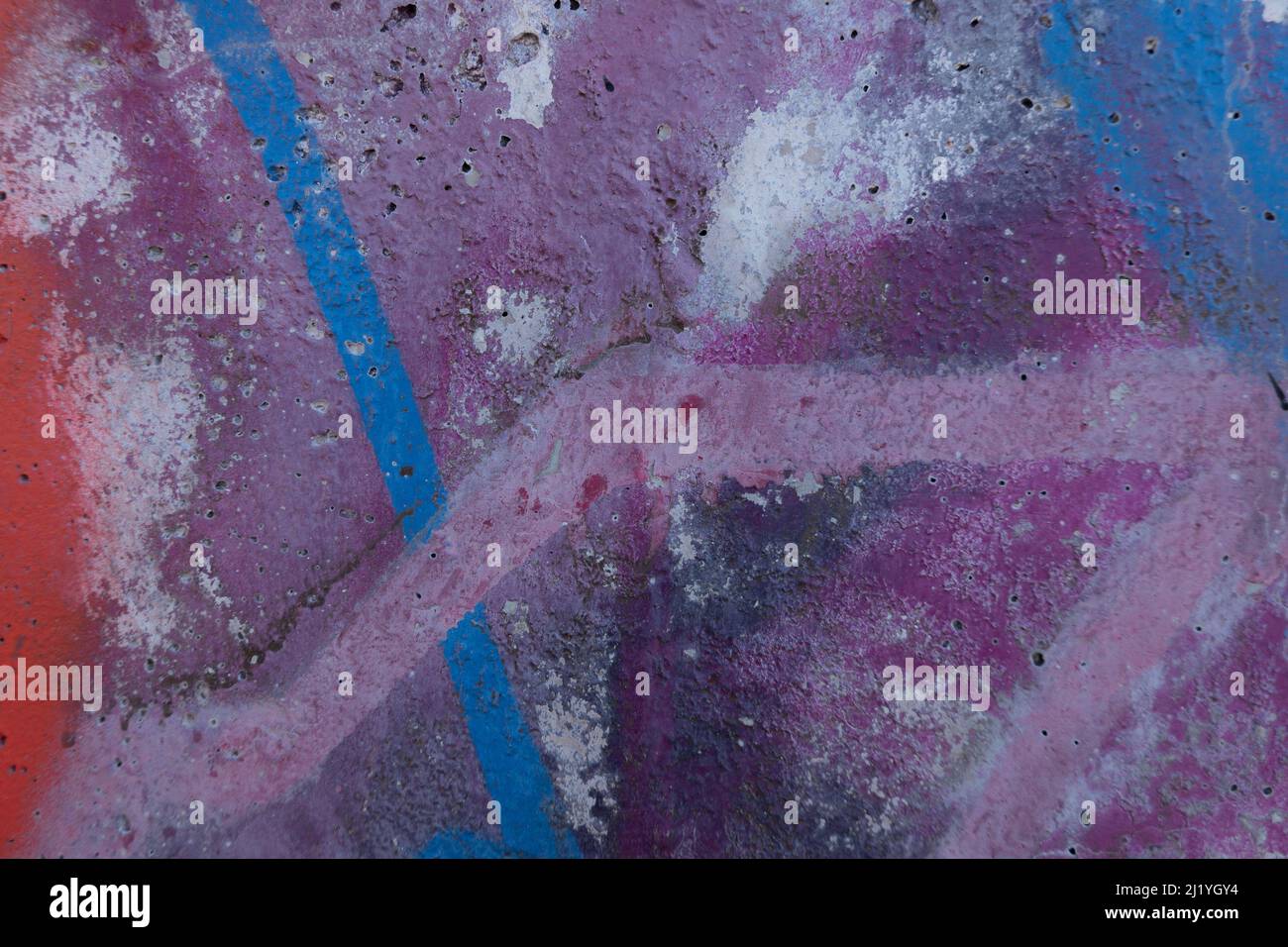 Fragment of stucco plaster wall with graffiti painting. Part of ...