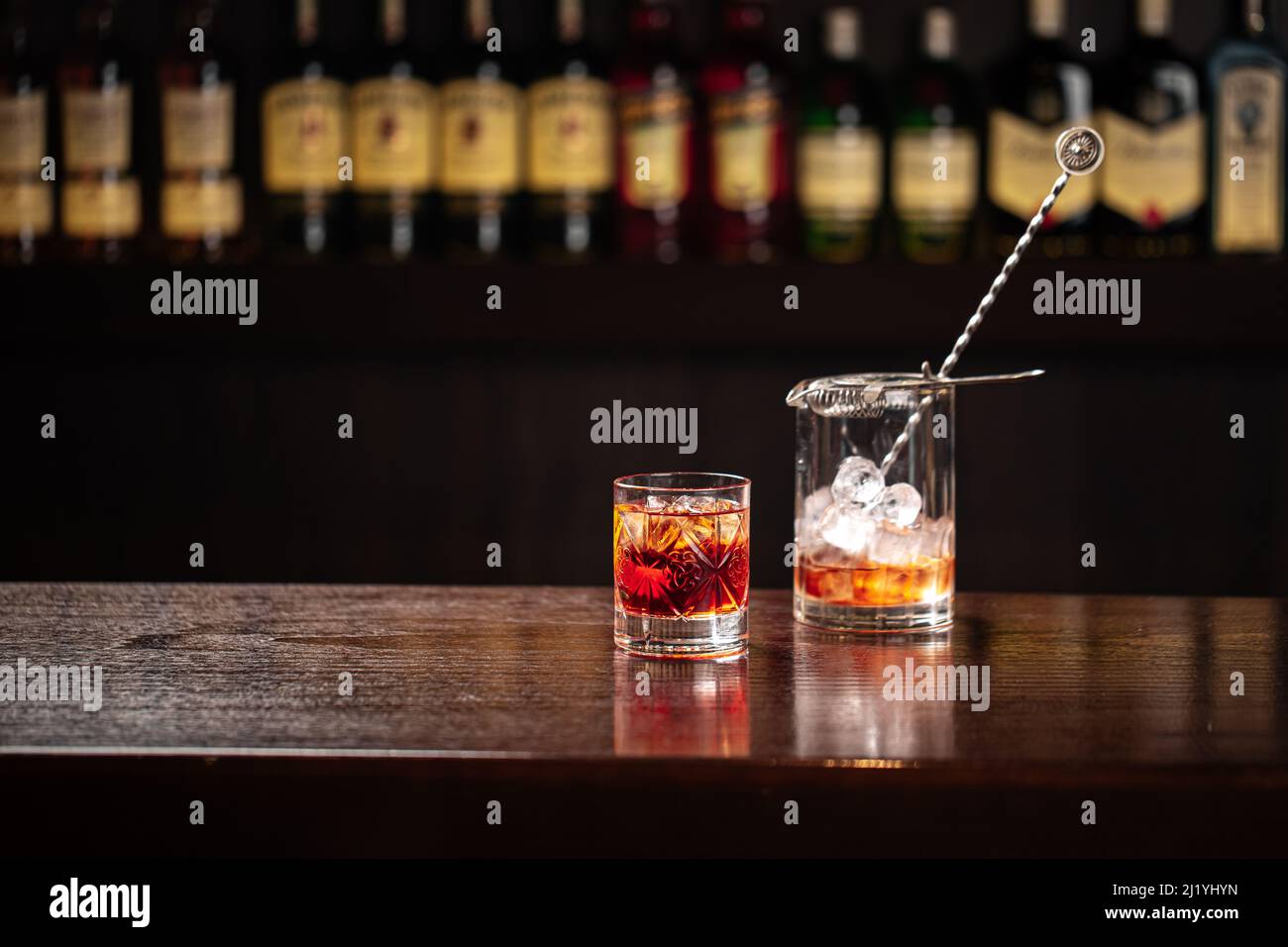 Crystal glass of classic negroni cocktail with ice Stock Photo - Alamy