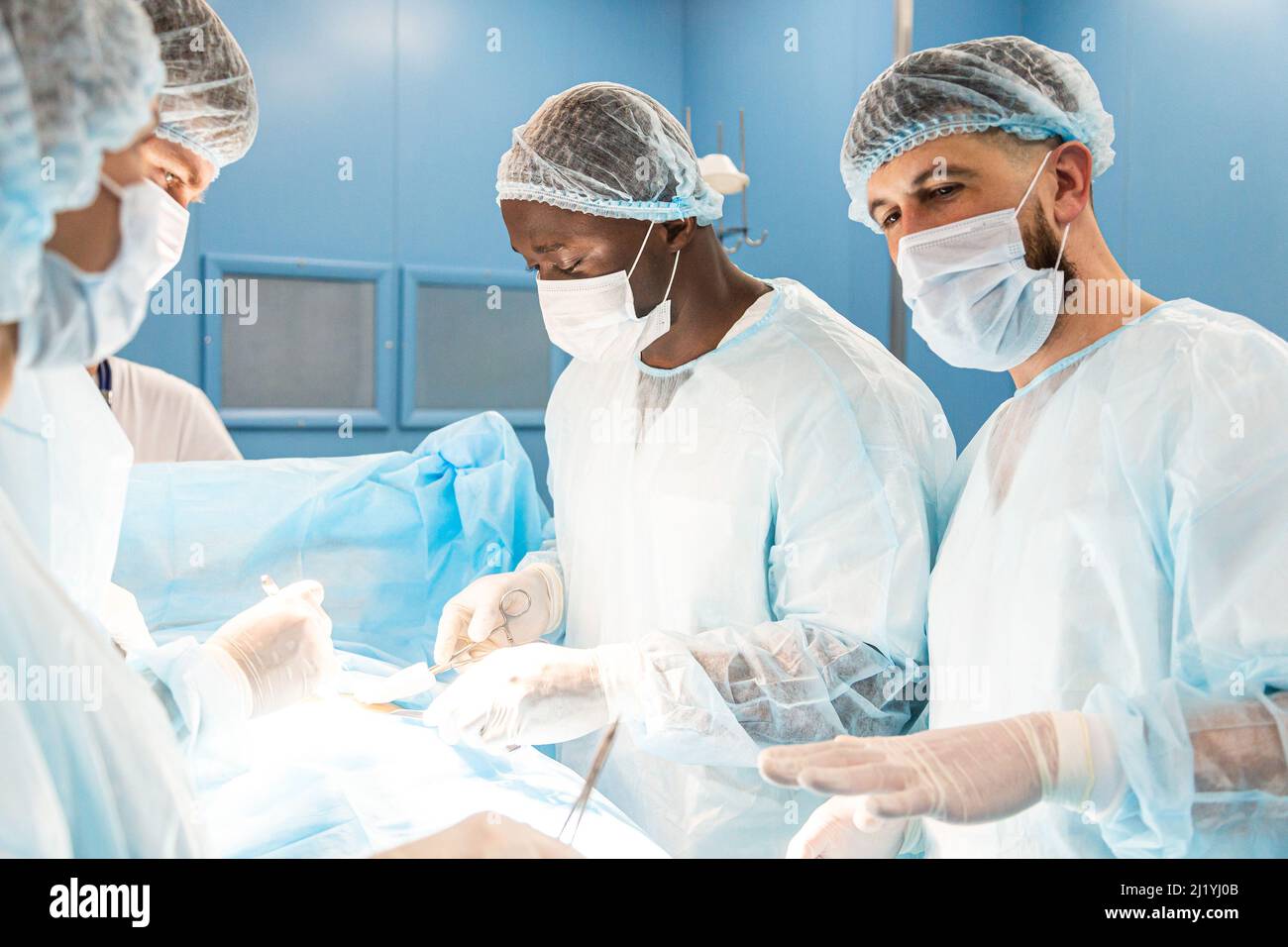 An international team of doctors performs a complex surgical operation ...