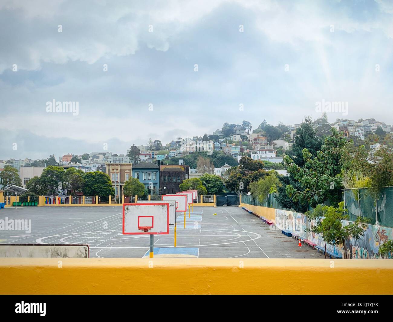 A view of the empty basketball playground and the beautiful town in the ...