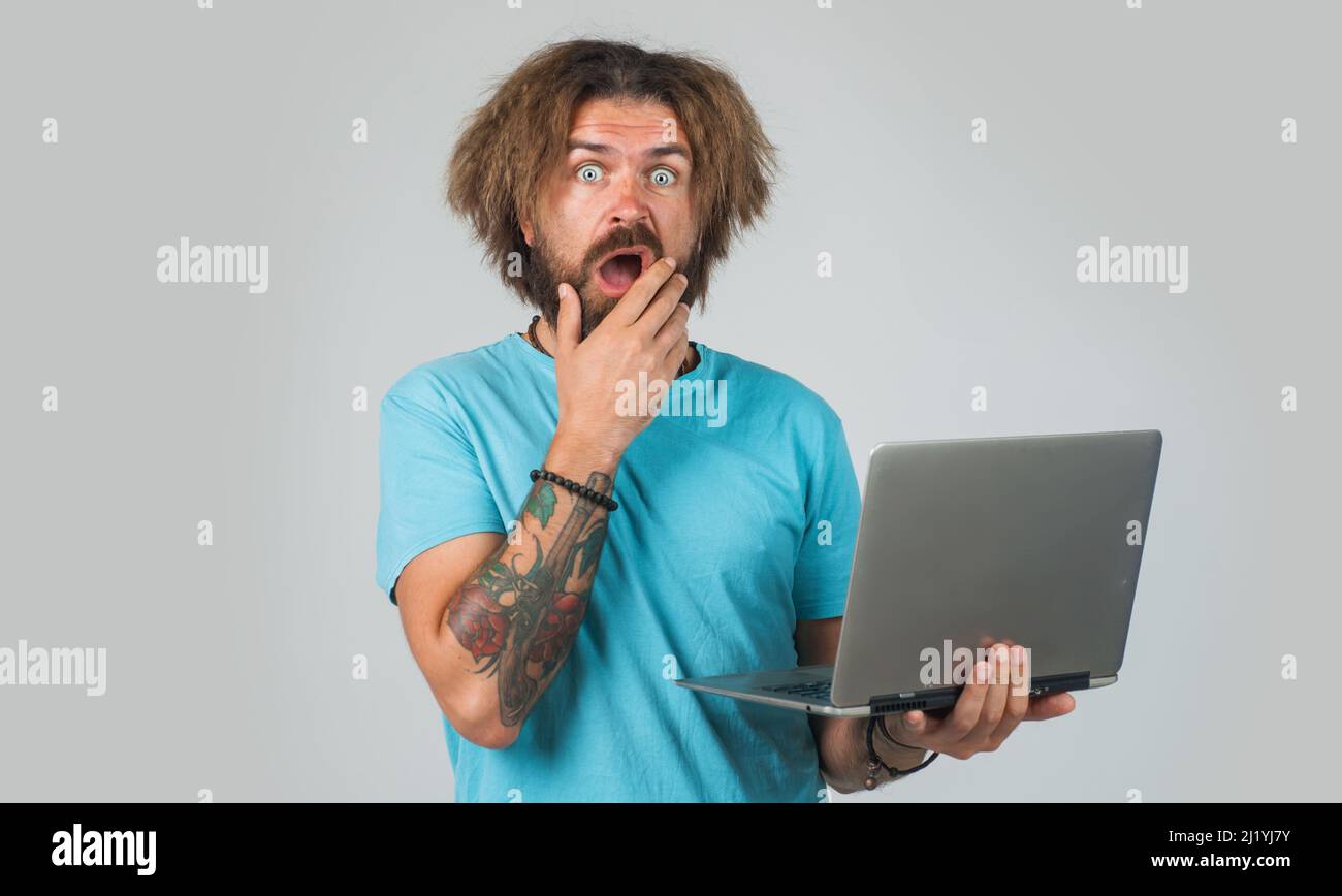 Surprised man with laptop. Work from home. Bearded guy working on pc ...