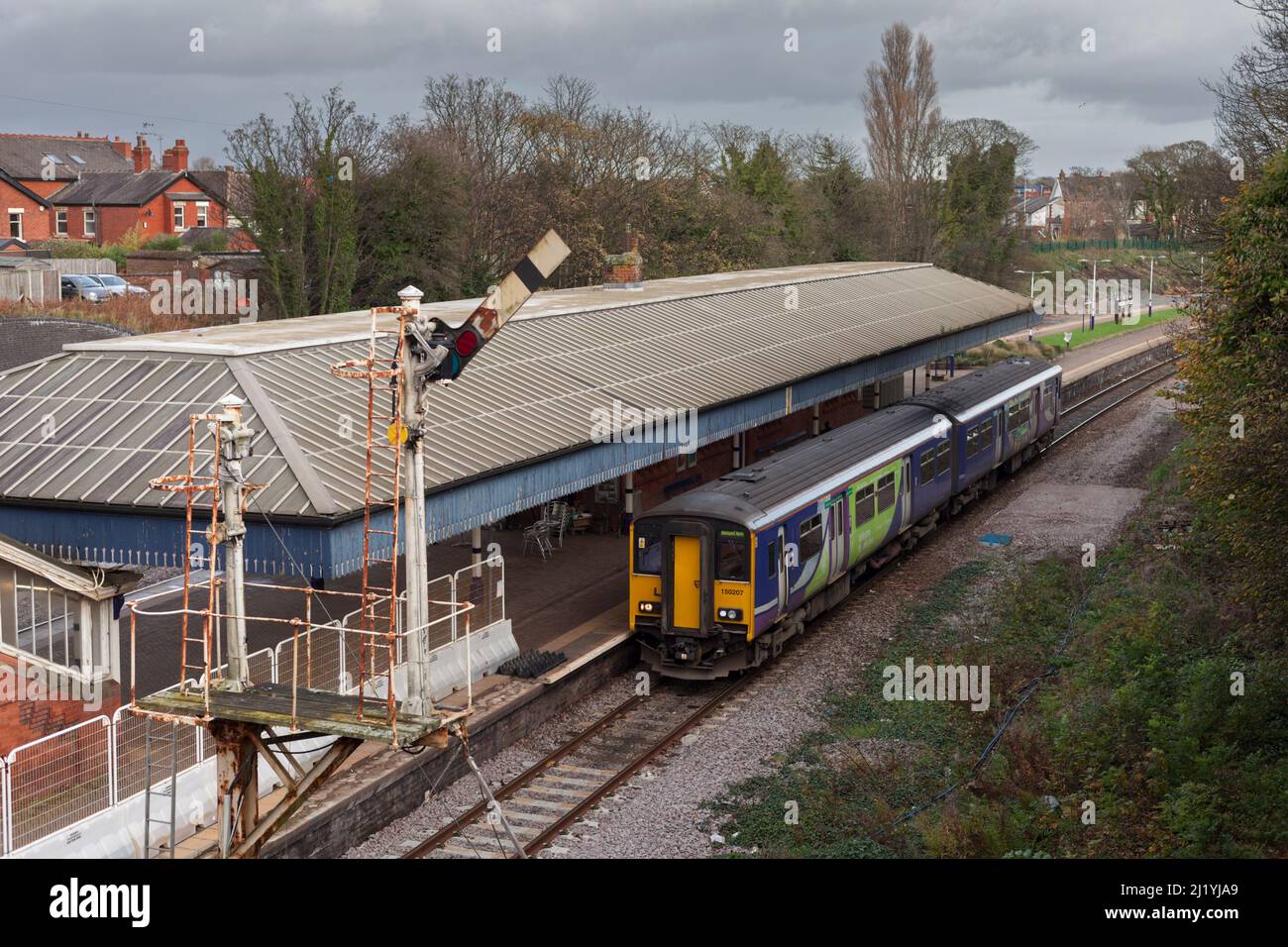 Poulton Le Fylde with the mechanical semaphore bracket signal in the off position. Northern rail ...
