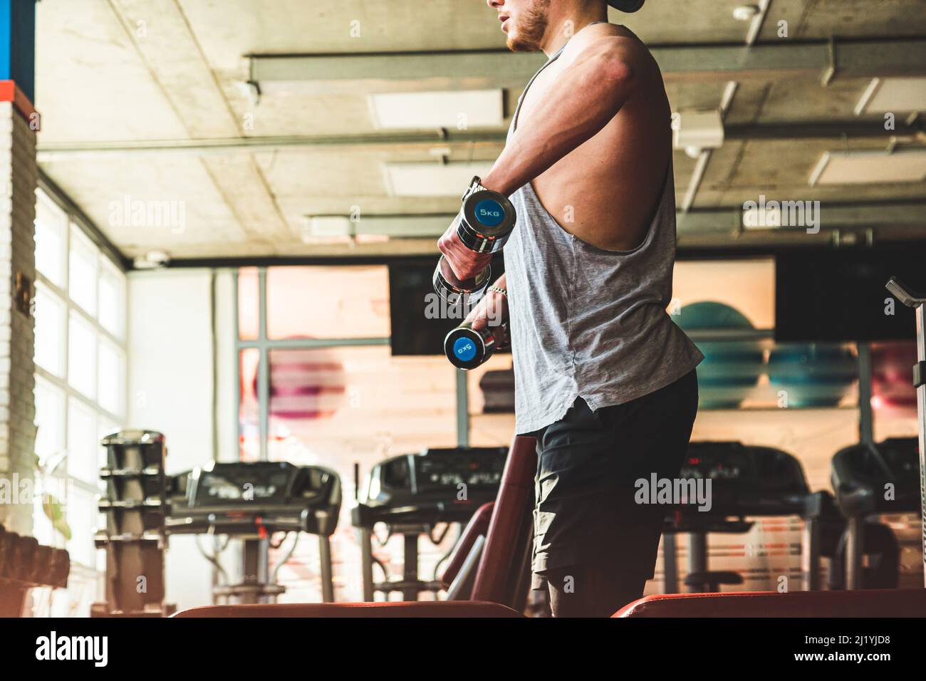 Training with dumbbells in the gym. Strength exercises for endurance ...