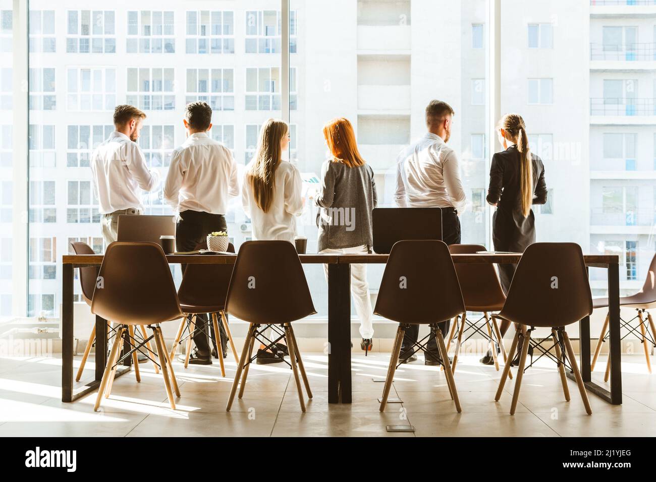A team of young businessmen working and communicating together in an ...