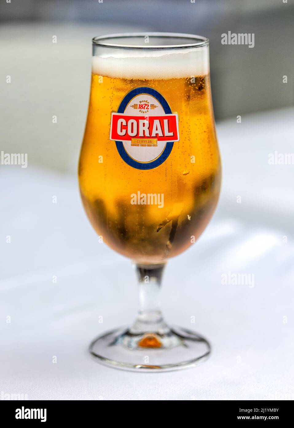 Funchal, Madeira, Portugal - March 09, 2022: glass of Coral beer on ...