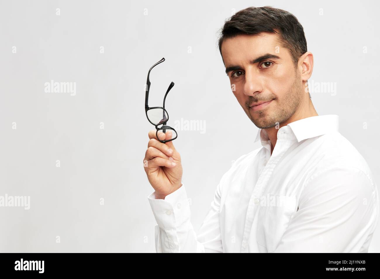 successful man holding glasses in hand in white shirts hand gesture ...
